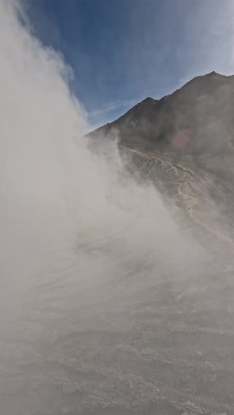 Tropical volcano crater ridge stone texture with mist fog and acid lake ...