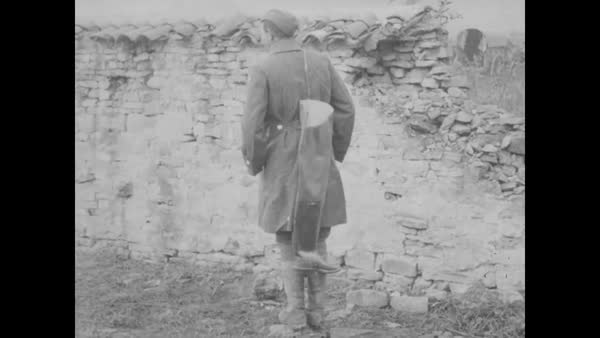 1918 - An American soldier models a new uniform, while others shower in ...