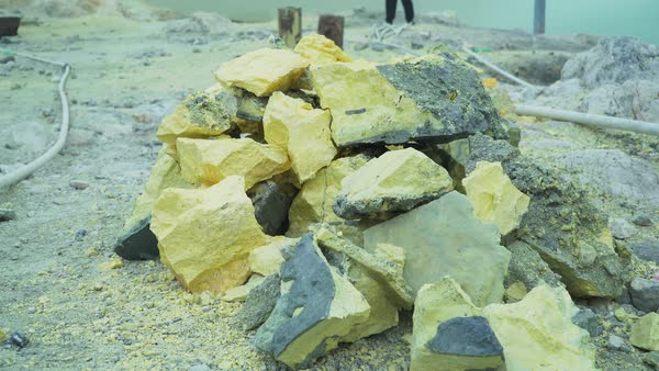 Extraction of sulfur in the crater of a volcano. Sulfur gas, smoke ...