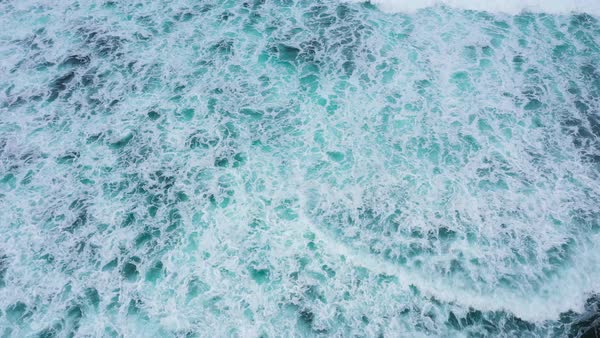 Texture of beautiful wave in the ocean. Sea waves with foam near the ...