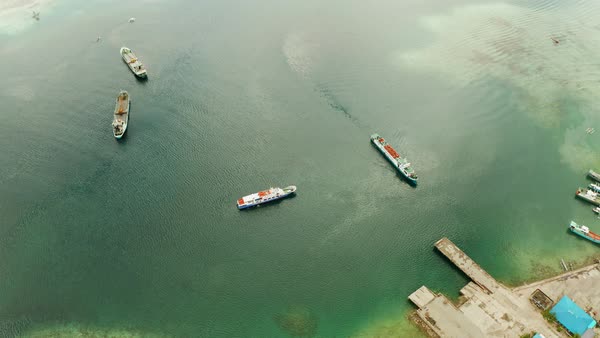 Freight ships and ferries in the bay, top view. Dapa Ferry Terminal ...