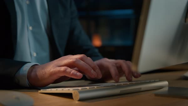 Close-up hands unknown Caucasian man typing on wireless keyboard ...