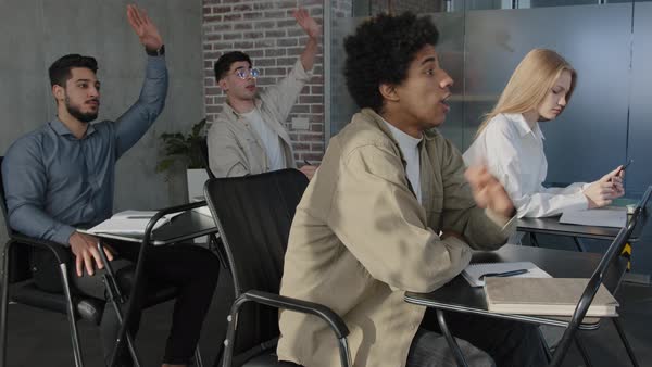 Students sit at desk in classroom at lesson young group people ...