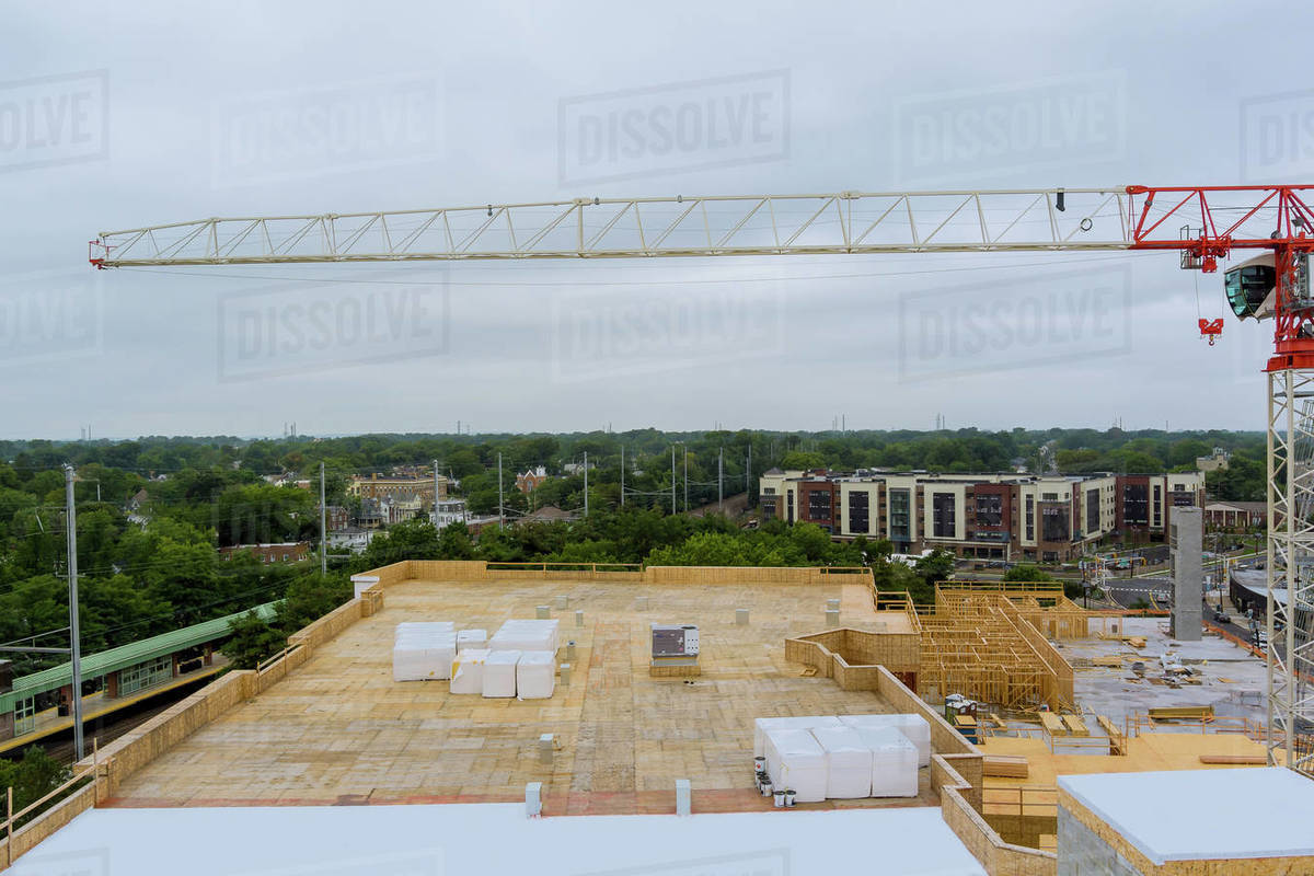 Under construction tower cranes over building site during house aerial ...