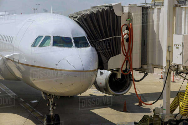 Aircraft at boarding bridge jetway connected to the airplane for ...