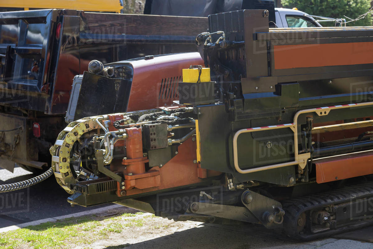 A trencher machine used to dig trenches for laying pipes on under ...
