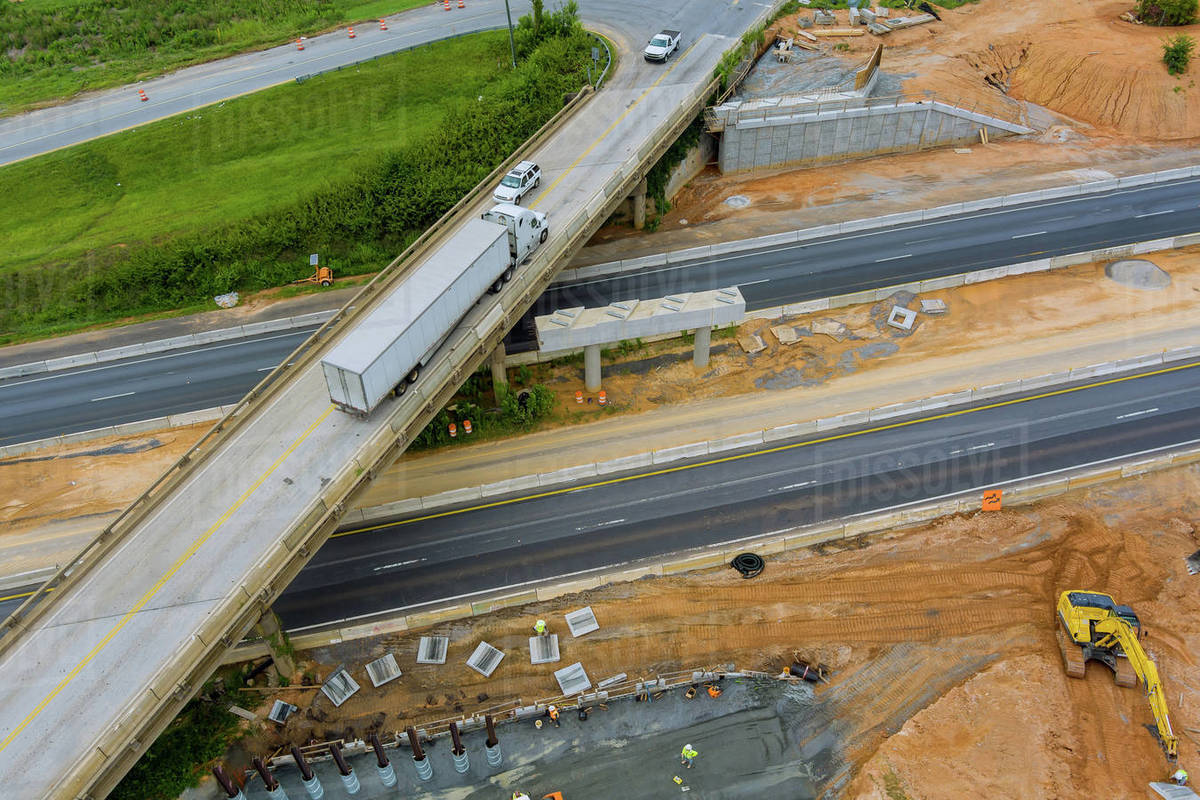 Overhead view of under construction works in highways of a bridge over ...