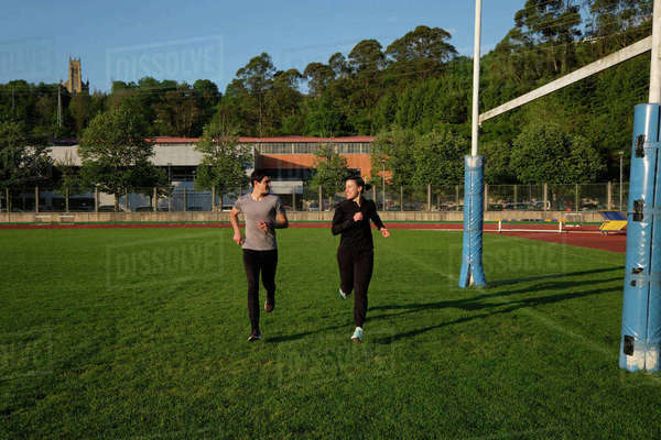 two young adult athletes competing against each other to win a friendly ...