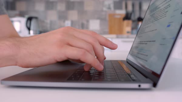 Hands open laptop on kitchen. Action. Young man opens laptop at kitchen ...