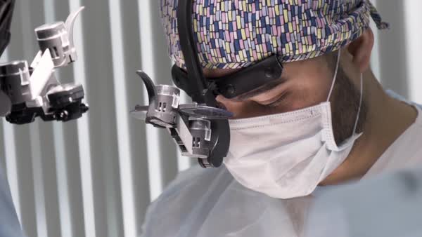 Two surgeons working at the operating clean room. Action. Two male ...