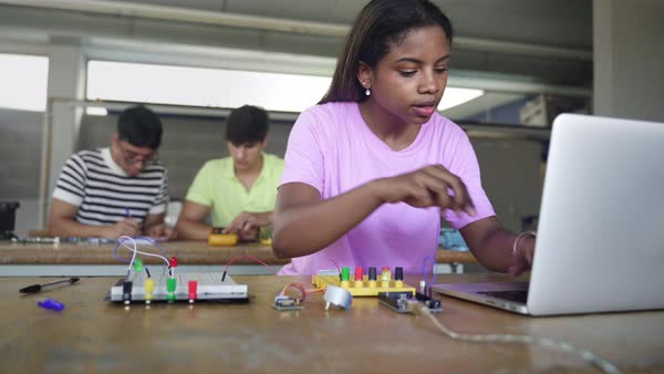 African American High School teenage Student programming electronics ...