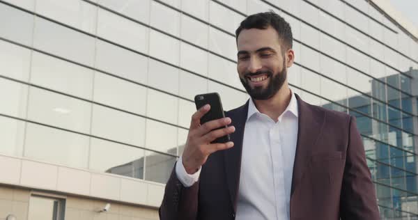 Tall Handsome Man standing by the Huge Building. Attractive man holding ...