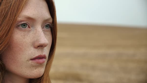 Portrait of calm ginger woman, with hair and freckles on face, opening ...