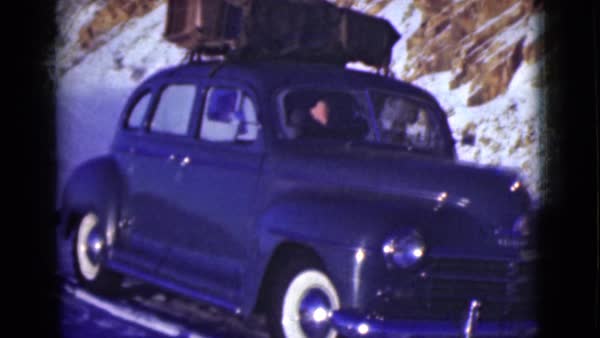 1946: a man freezing inside his 1950's purple vehicle with white wall ...