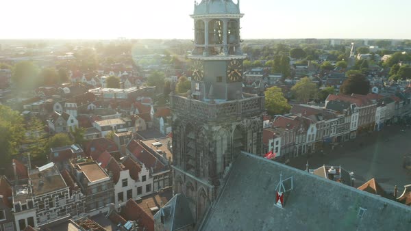 Sunlight Through Clock Tower Of Sint Janskerk With Old City Hall In ...