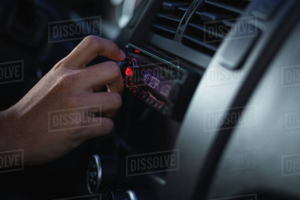 person playing music on the radio of his car while driving - Royalty ...
