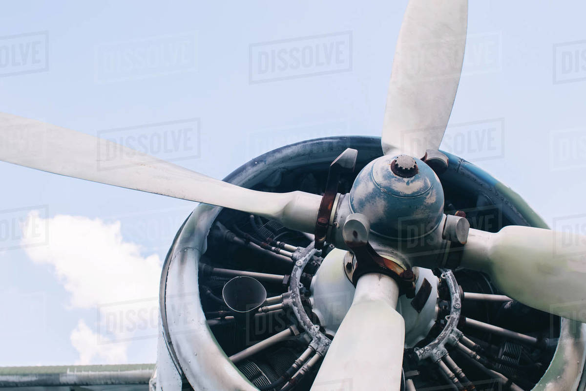 A close-up of an old aircraft engine showing rust and breakage. Visible ...