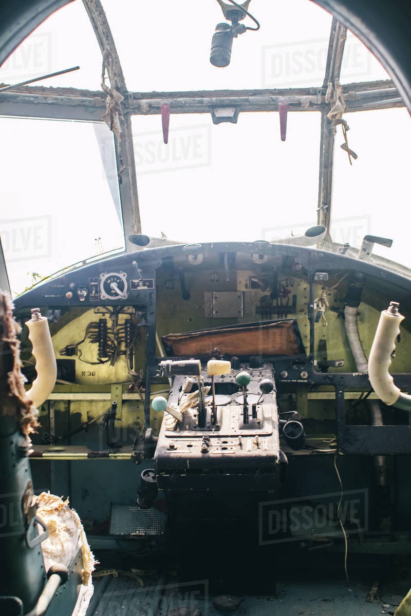 A close up of the cockpit of a vintage airplane. The steering wheel ...