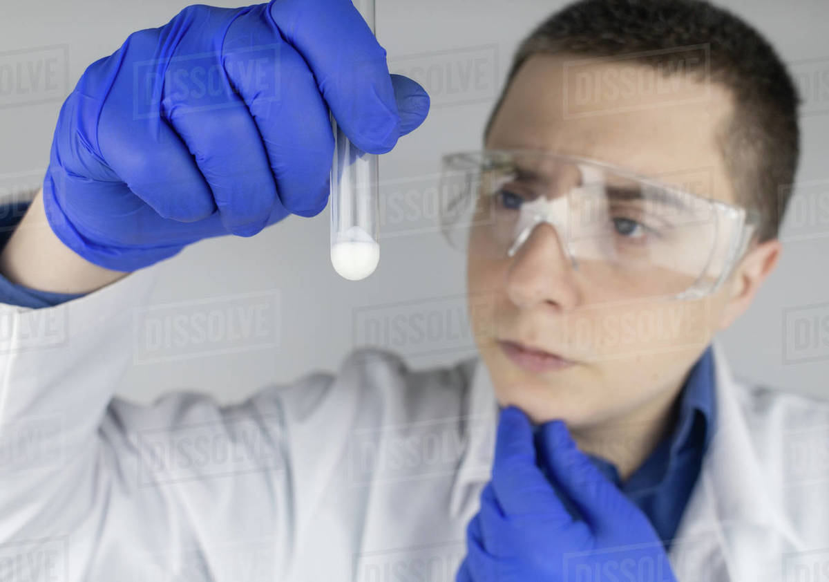 Medical laboratory assistant checks a test tube with sperm. Spermogram ...