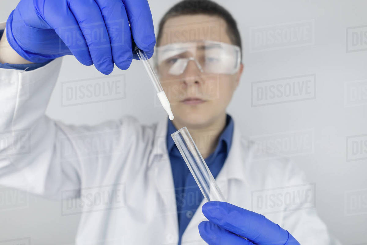 Medical laboratory assistant checks a test tube with sperm. Spermogram ...