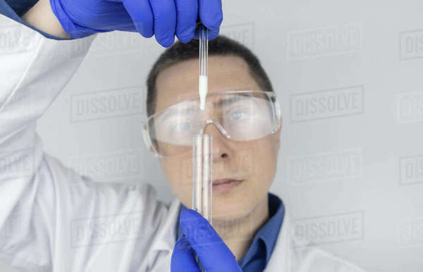 Medical laboratory assistant checks a test tube with sperm. Spermogram ...