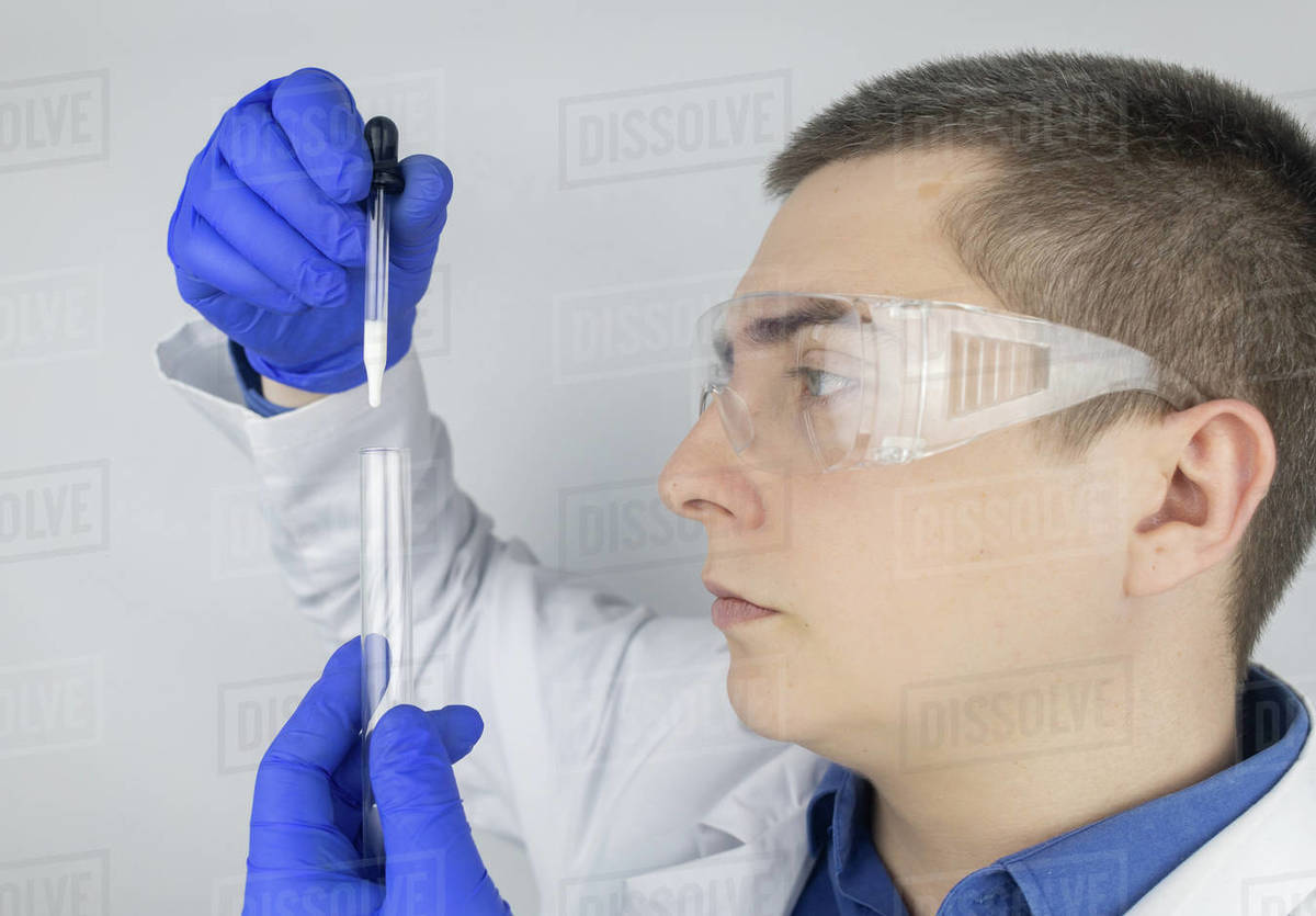 Medical laboratory assistant checks a test tube with sperm. Spermogram ...