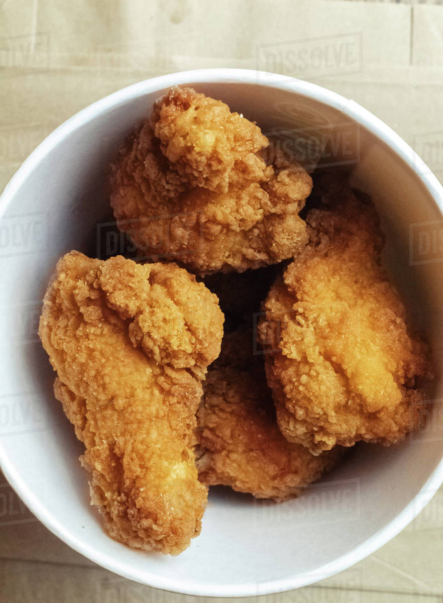 Close-up of chicken wings fried in batter. In a fast food restaurant ...