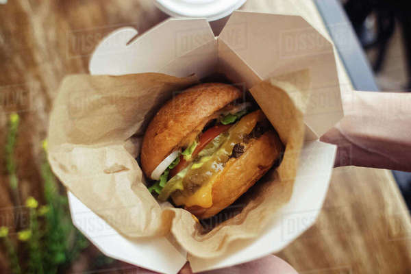 Close-up of a standard burger. Adult fast food in a restaurant or cafe ...