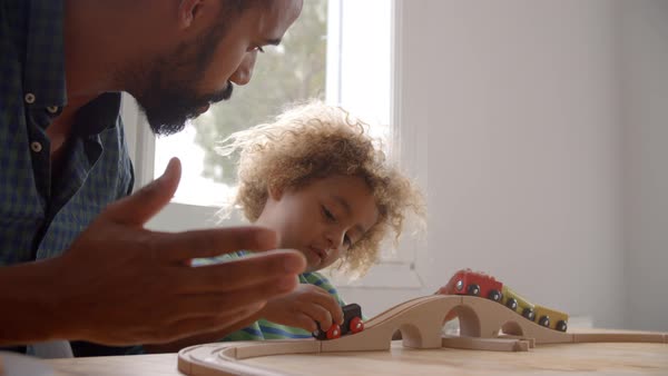 Father and son playing with toy train set - 4K Royalty-free Stock Video ...