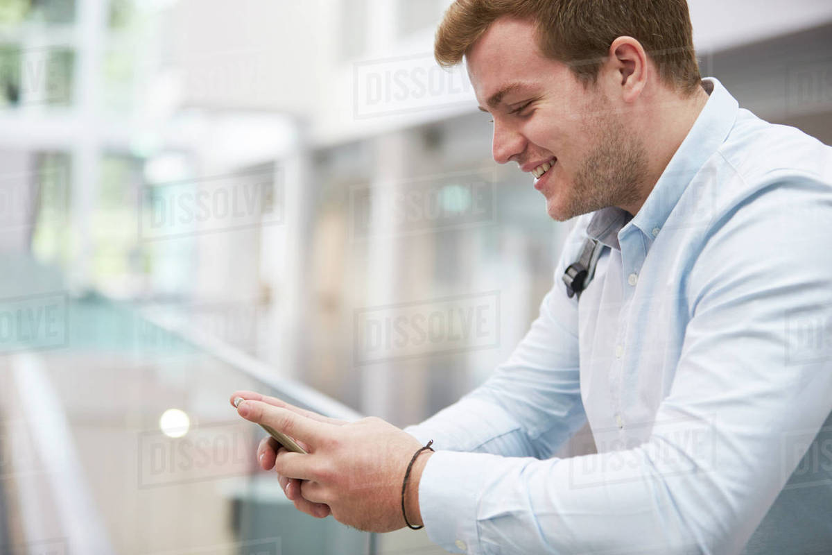Adult male student using smartphone in university, close up - Stock ...