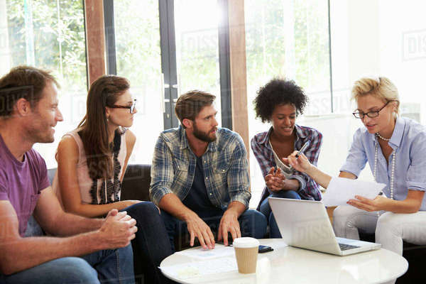 Businesspeople having informal meeting in modern office - Royalty-free ...