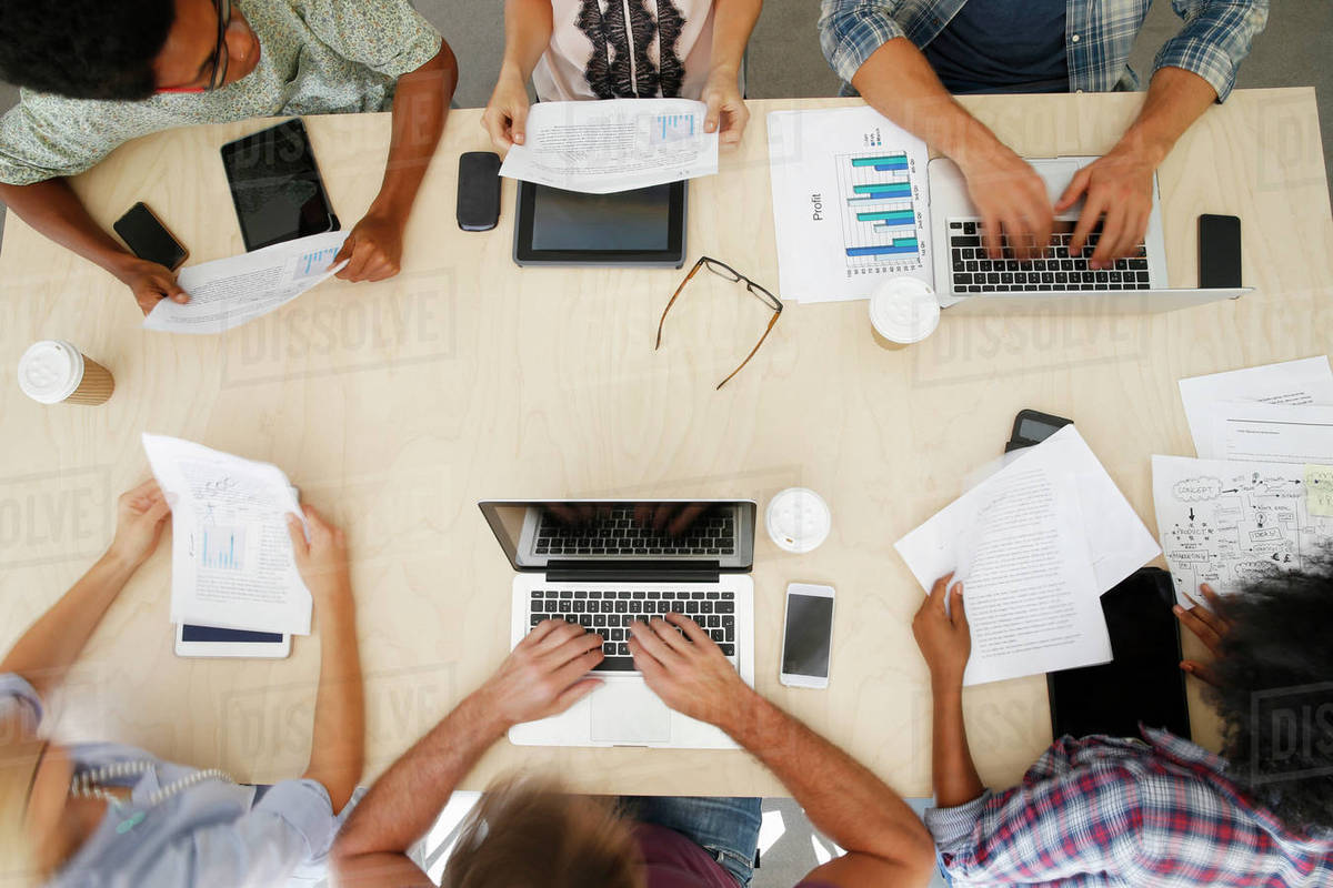 Overhead view of staff with digital devices in meeting - Stock Photo ...