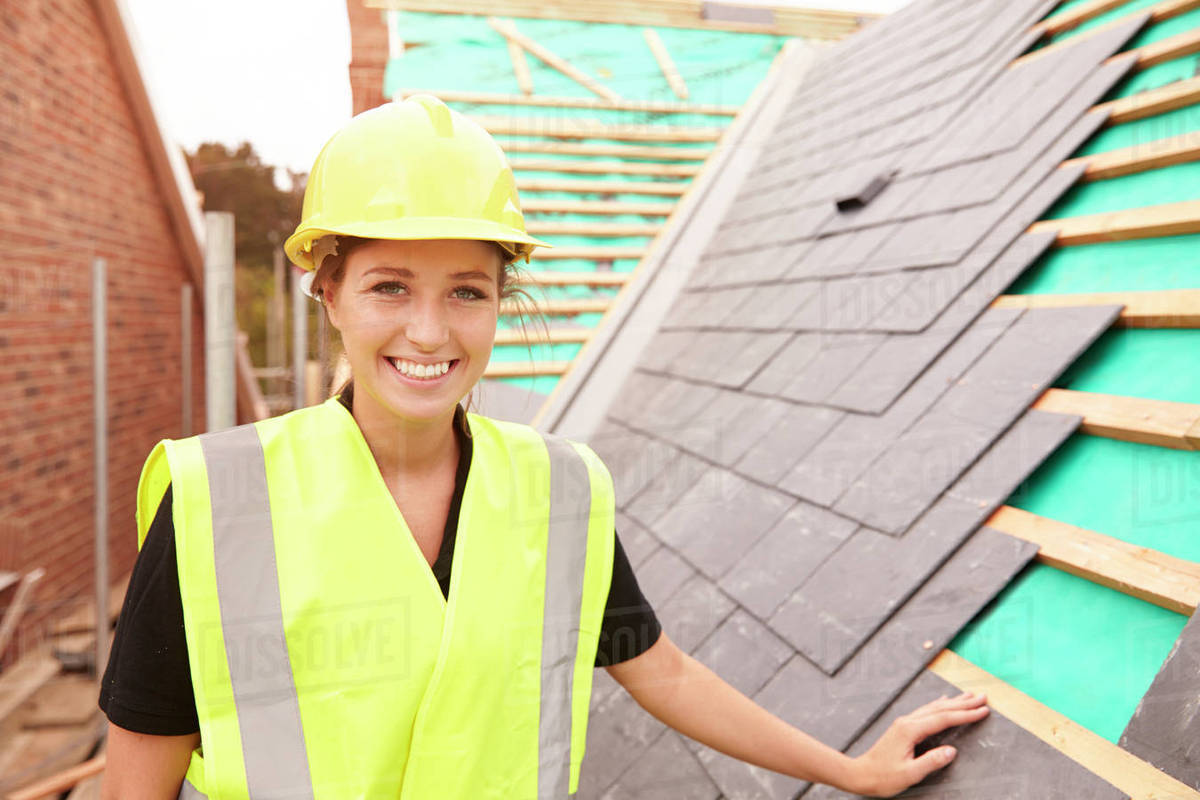 Female construction worker on site laying slate tiles - Royalty-free ...