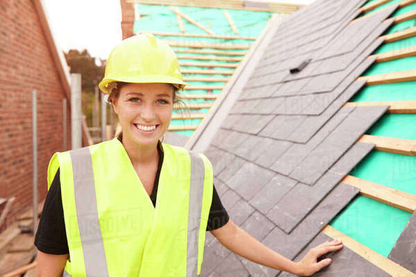 Female construction worker on site laying slate tiles - Royalty-free ...