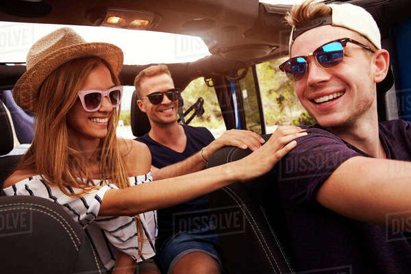 Group Of Friends Driving Open Top Car On Country Road - Royalty-free ...