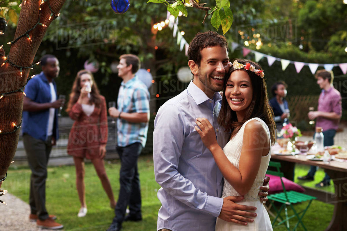 Portrait of couple celebrating wedding with backyard party - Royalty ...