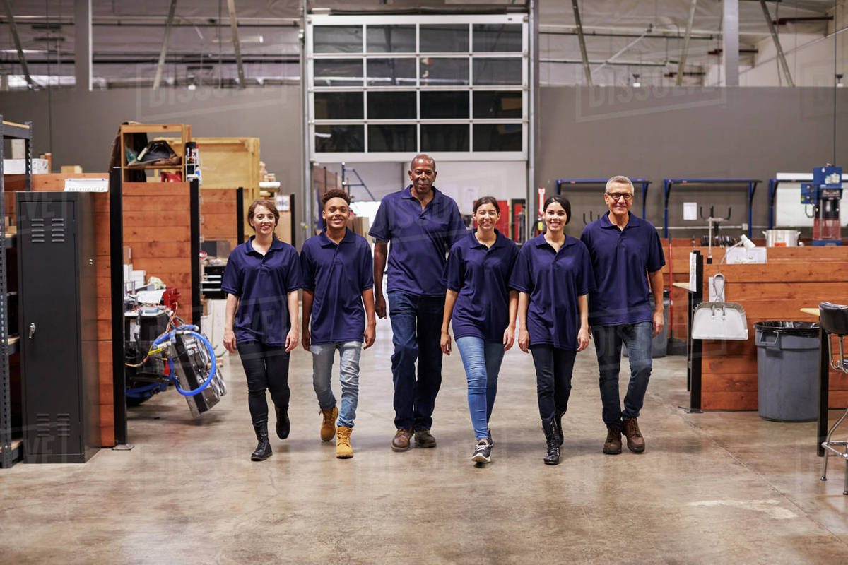 Interior of busy factory with staff at work benches - Royalty-free ...