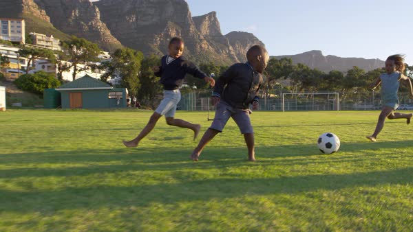 Elementary school kids playing football in a field - 4K Royalty-free ...