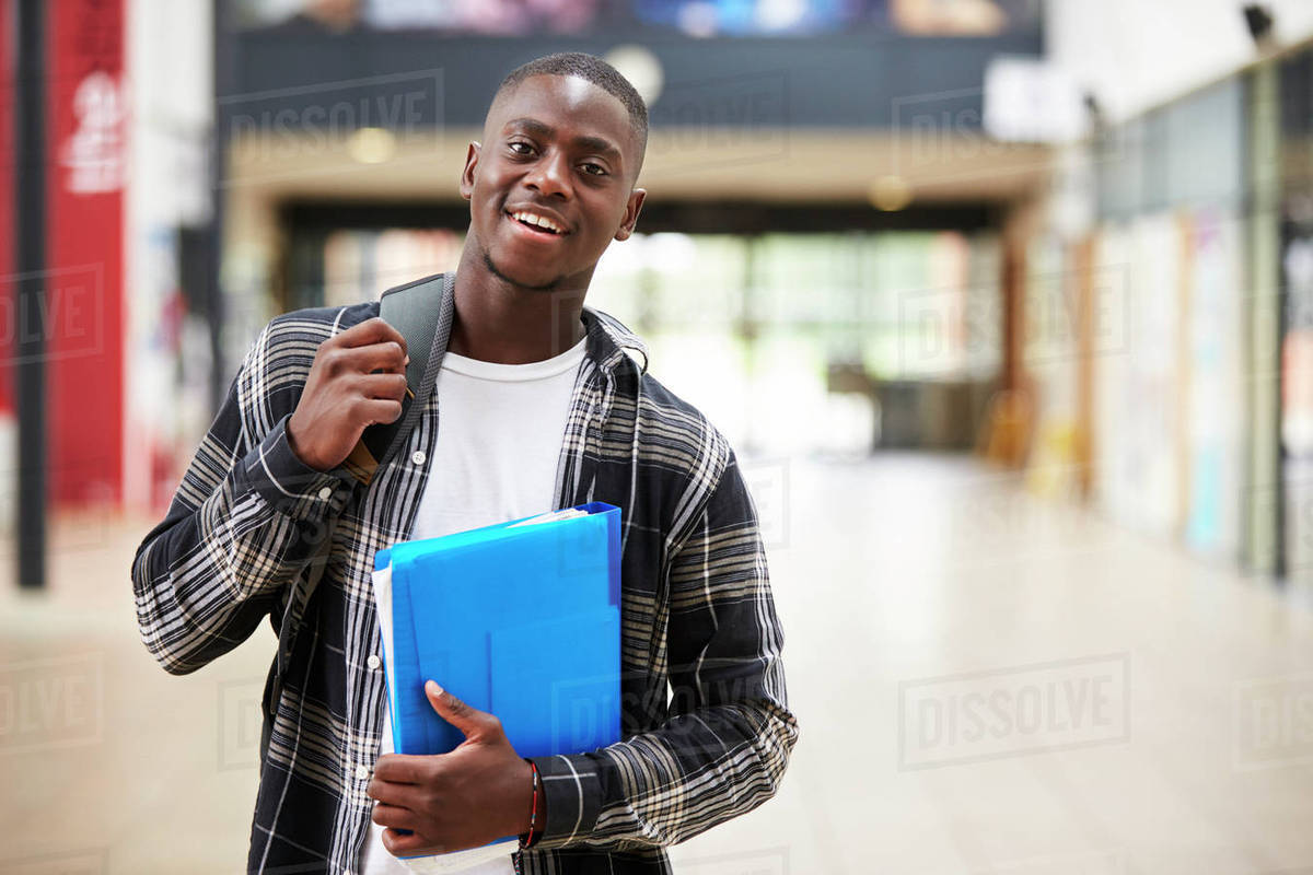 Portrait Of Male Student Standing In College Building - Royalty-free ...