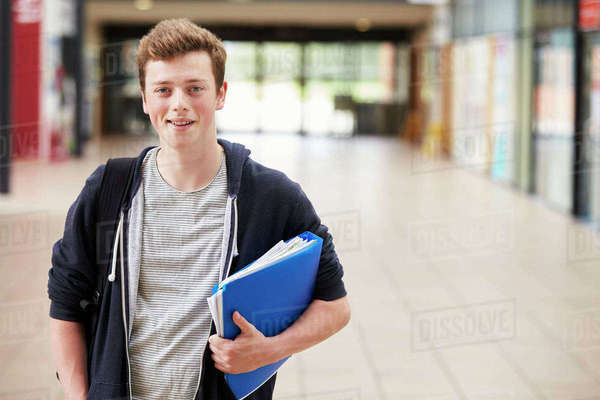 Portrait Of Male Student Standing In College Building - Royalty-free ...