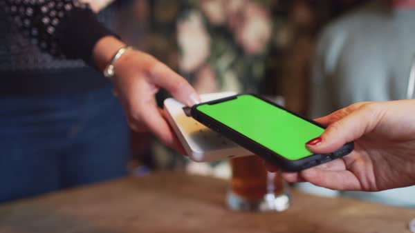 Close Up Of Customer Paying Bill In Bar Using Mobile Payment On Phone ...