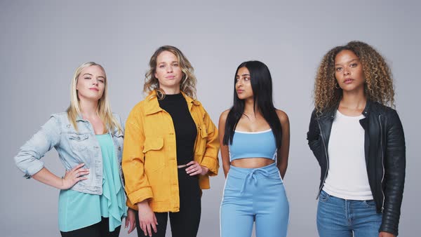 Group of female friends in studio going from serious to smiling ...