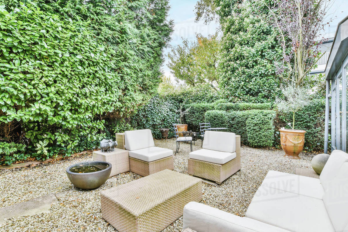 Beautiful backyard terrace full of furniture and decorative plants ...
