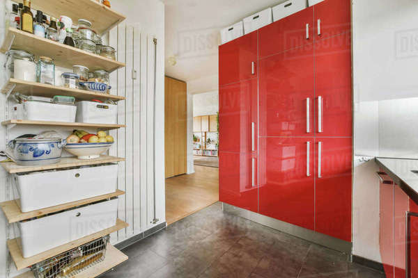 Stylish kitchen design with bright red kitchen set - Stock Photo - Dissolve