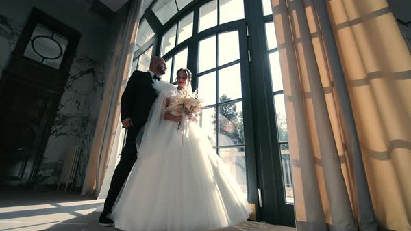 Sunbeam Wedding: Couple Poses by Window in Elegant Venue, The bride and ...