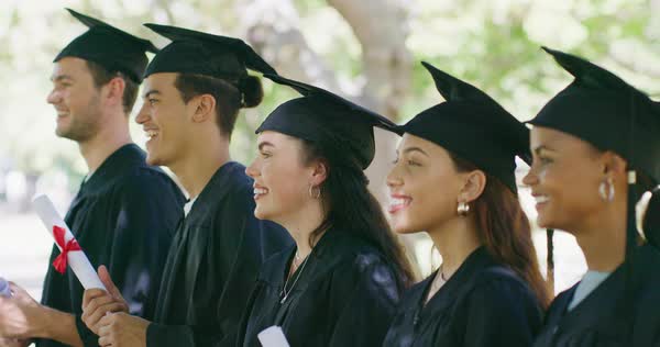 Group of university or college graduates in mortarboards and gowns ...