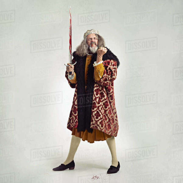 King, blood sword and man in celebration in studio isolated on a gray ...