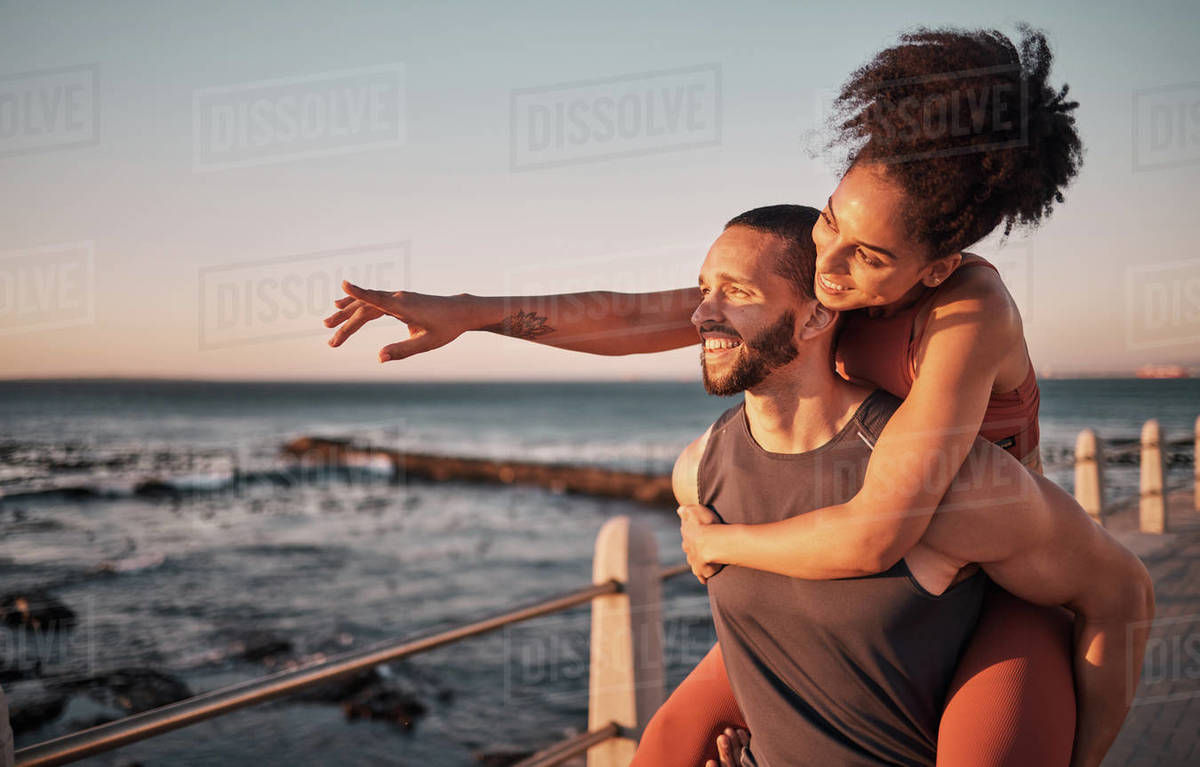 Fitness, couple and piggyback for beach sunset, travel or fun holiday ...