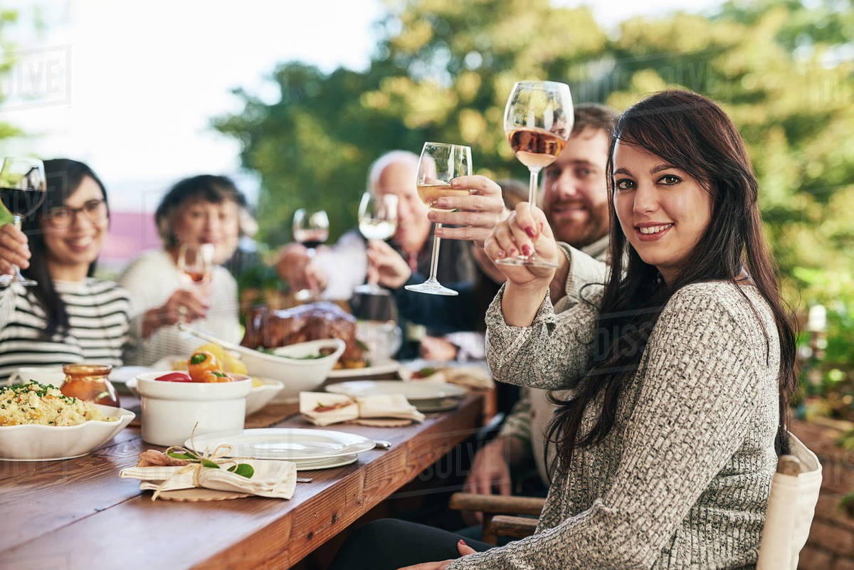 Toast, dinner and family with a group of people enjoying a meal ...