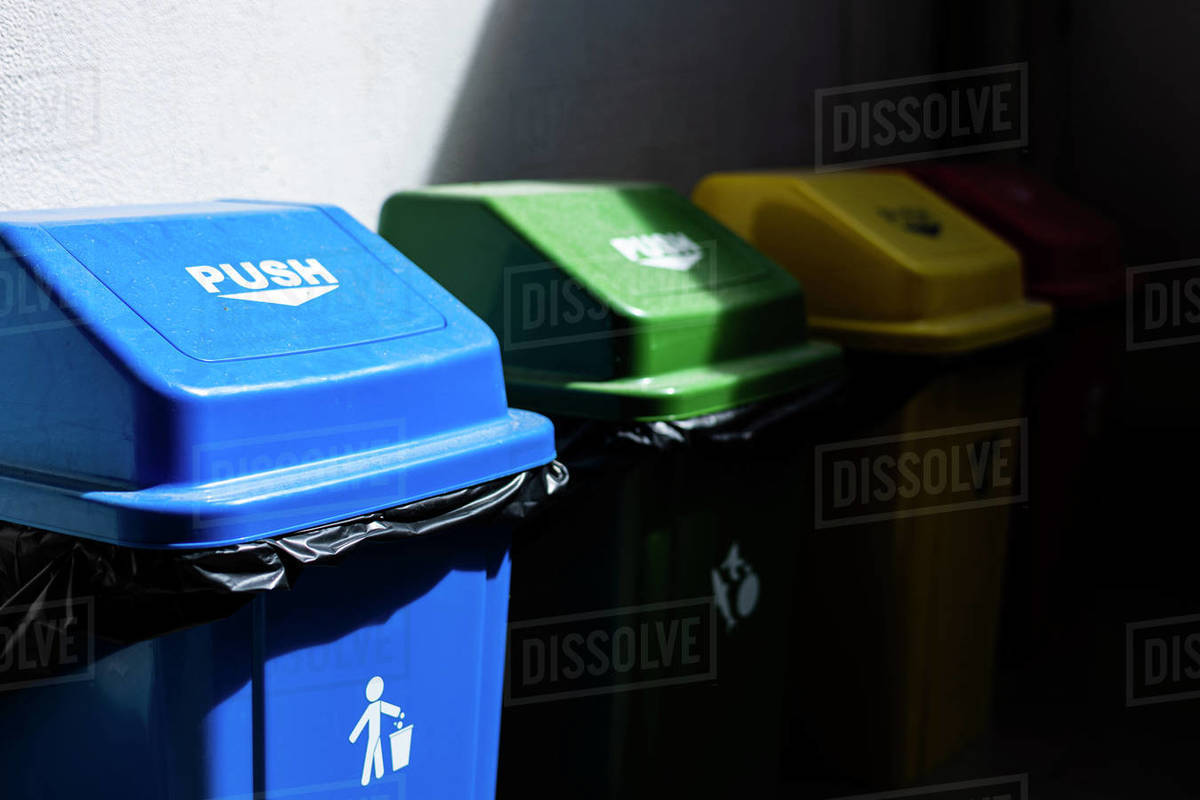 Multicolored Garbage Trash Bins. Recycle Bin on the floor and white ...